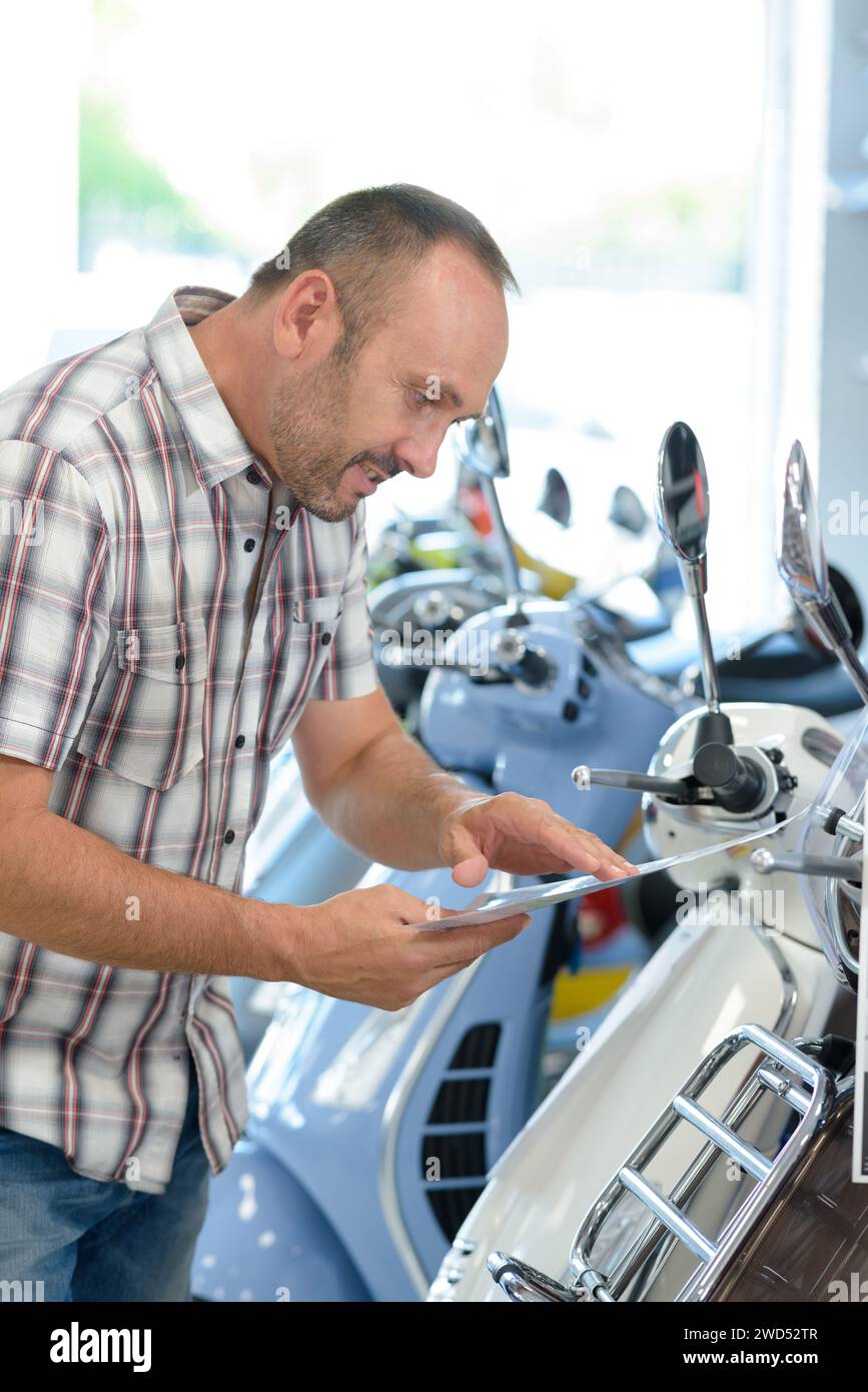 buying in a motorbike store Stock Photo - Alamy