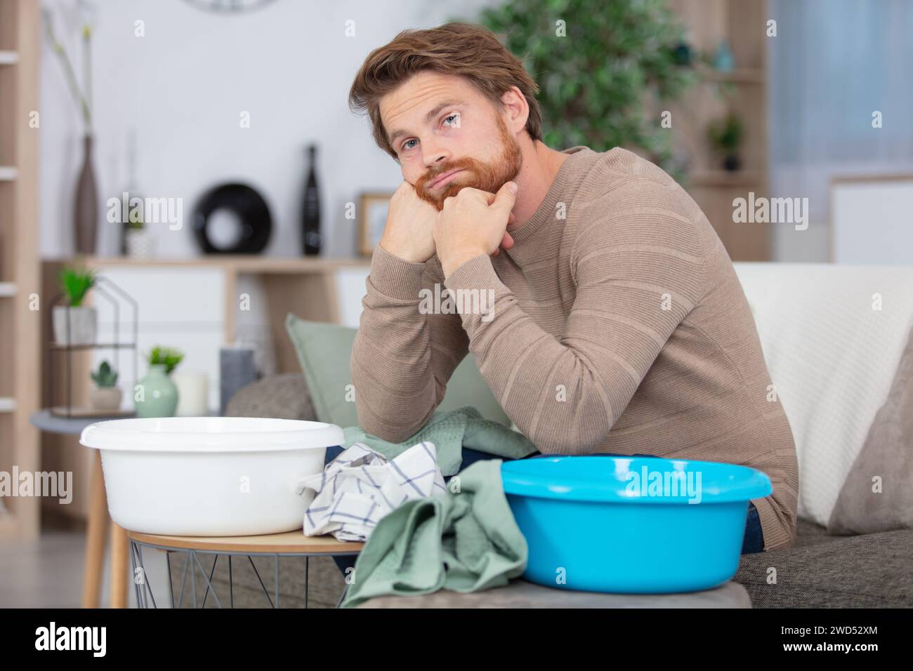 emotional young man under water leakage from ceiling Stock Photo - Alamy