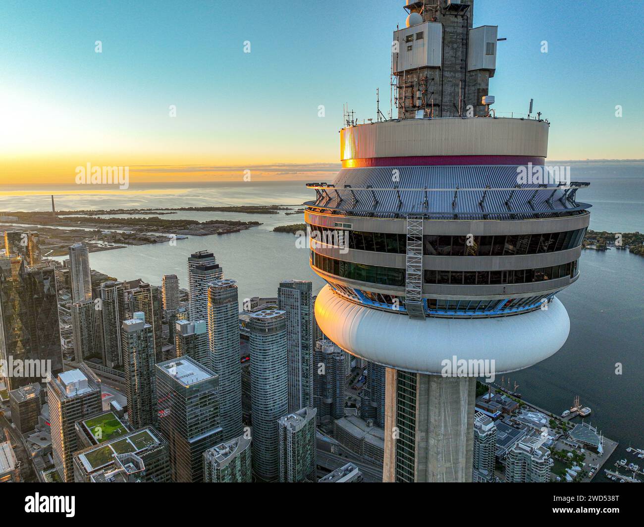 A majestic tower dominates a city skyline at sunset, offering a ...