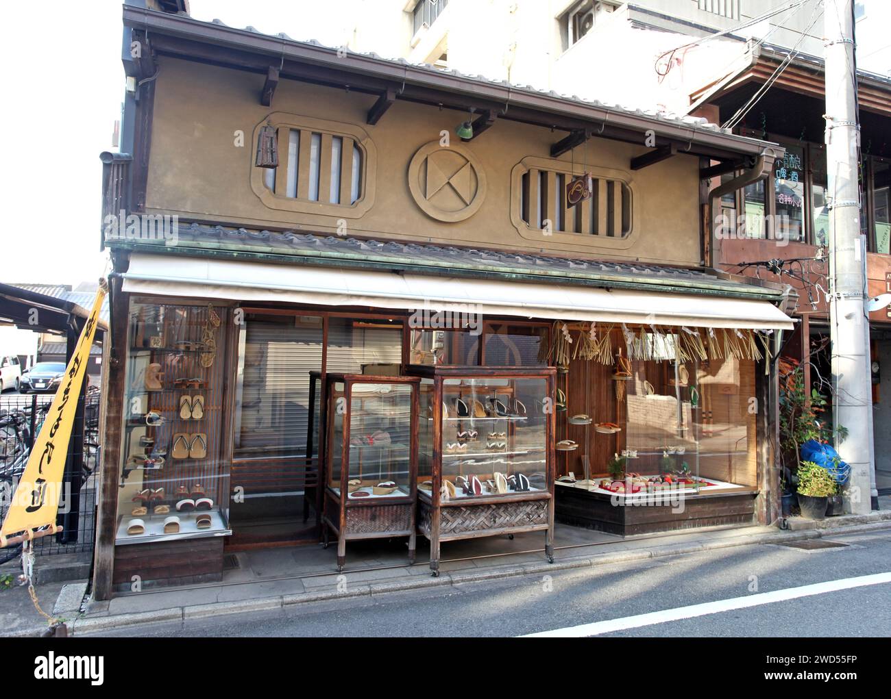 A display of geta or traditional Japanese sandals in a glass cabinet in ...
