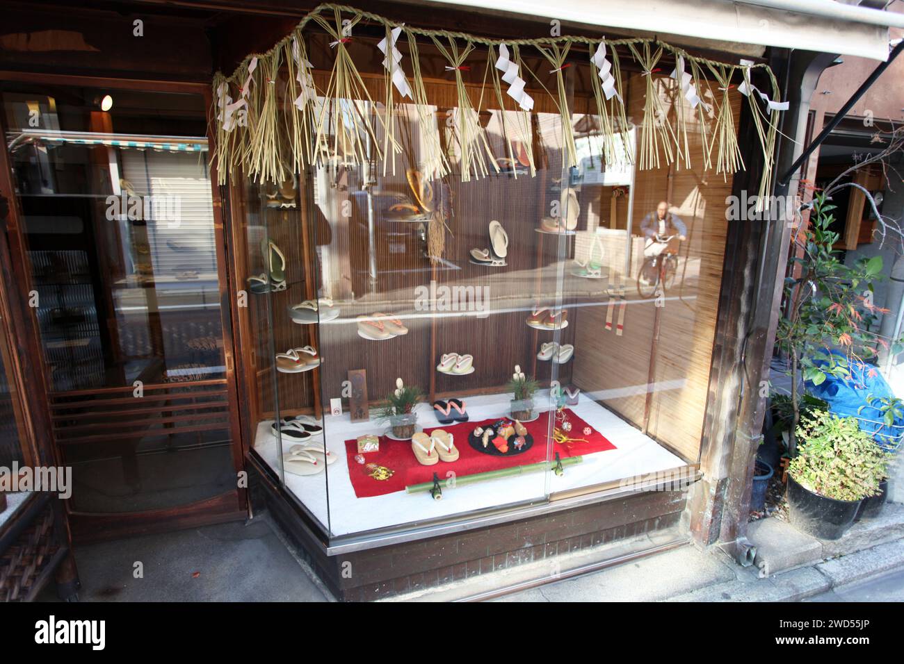 A display of geta or traditional Japanese sandals in a glass cabinet in ...