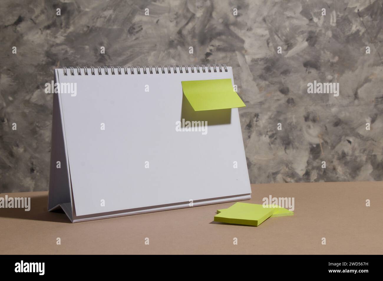 empty calendar table and blank green note paper attached, suitable for ...