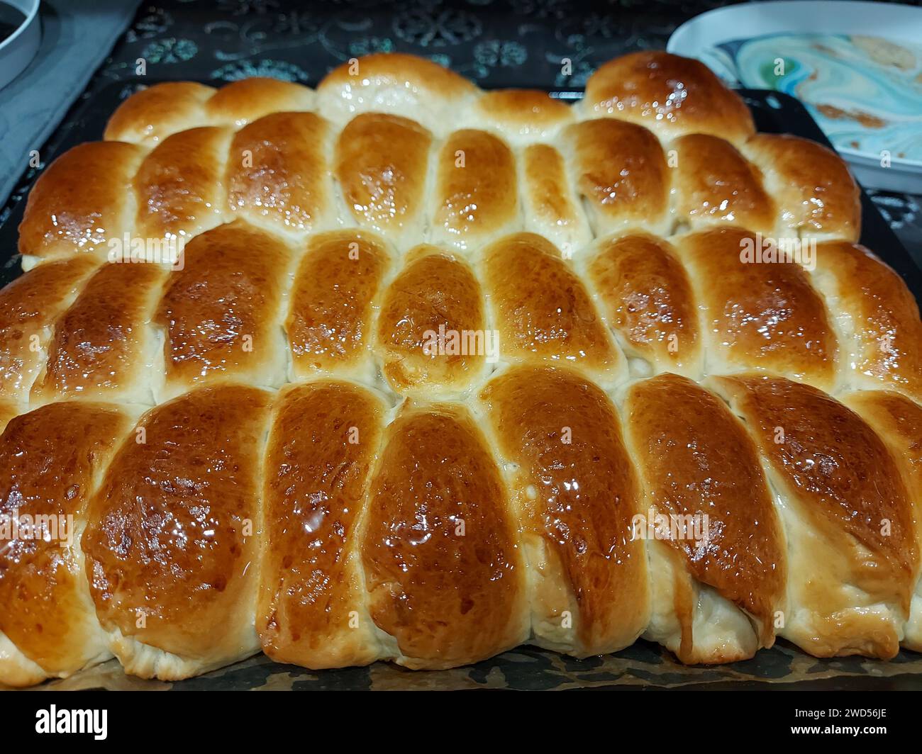 Sweet pies with filling lying on a baking sheet, top view Stock Photo ...
