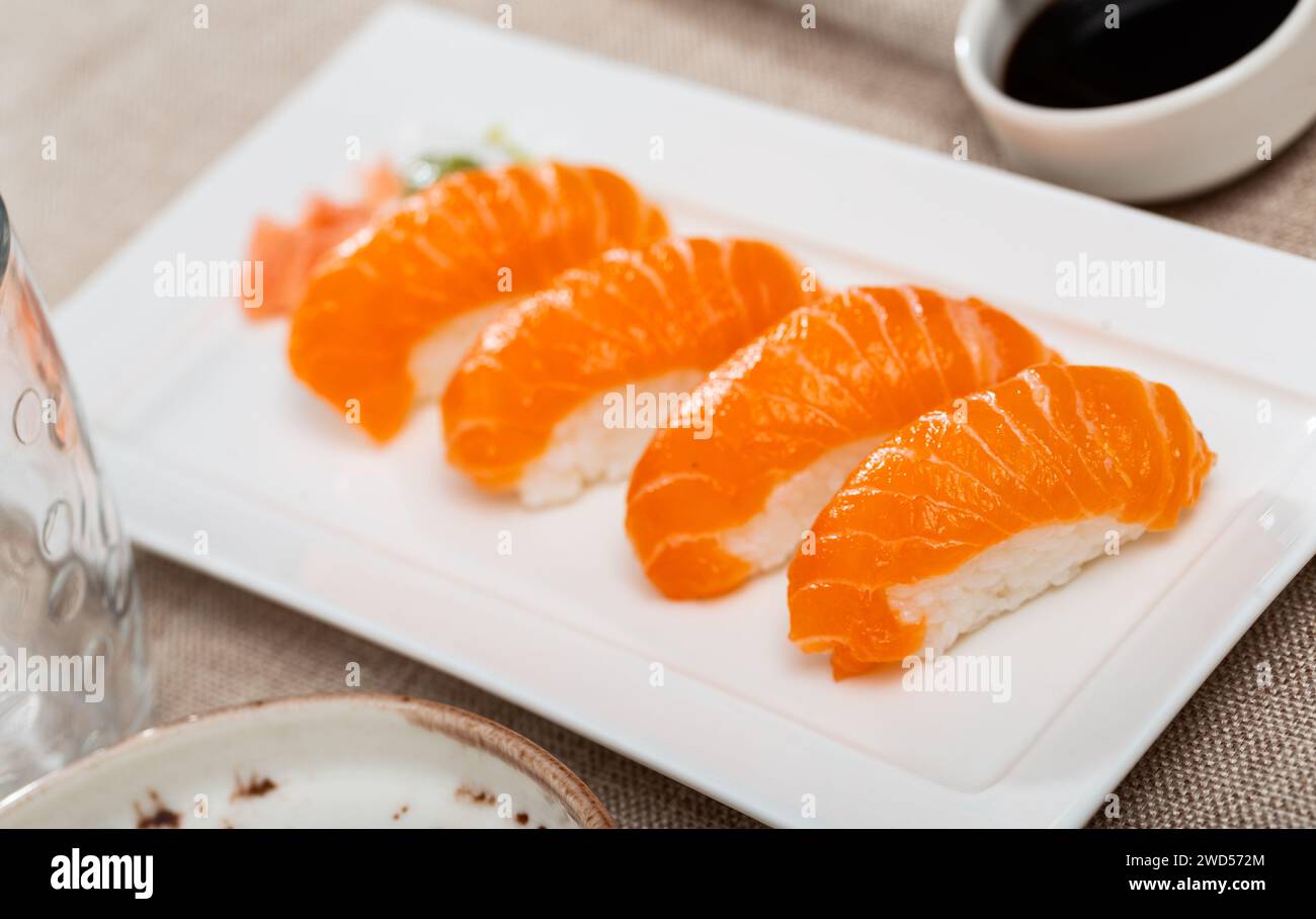 Sake Nigiri served in a plate with soya sauce Stock Photo - Alamy