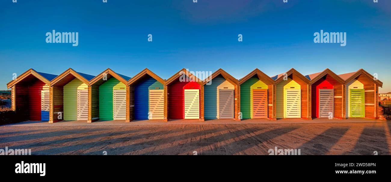 Panoramic view of the colourful beach huts on blyth promenade at dawn ...