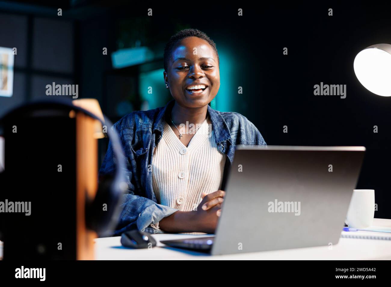 Black woman enjoying a comedy movie on her digital laptop, while seated ...