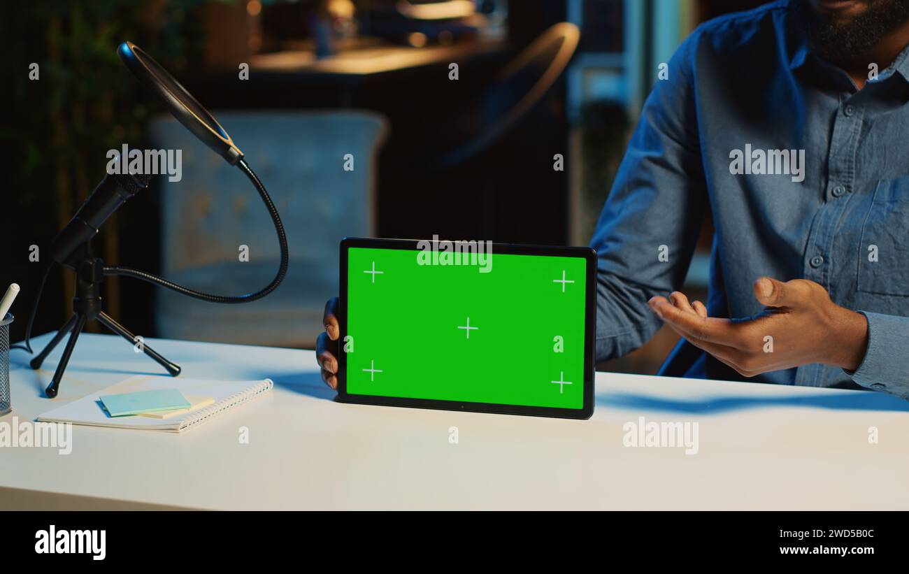 Content creator films chroma key tablet video review for tech enthusiasts using professional ...