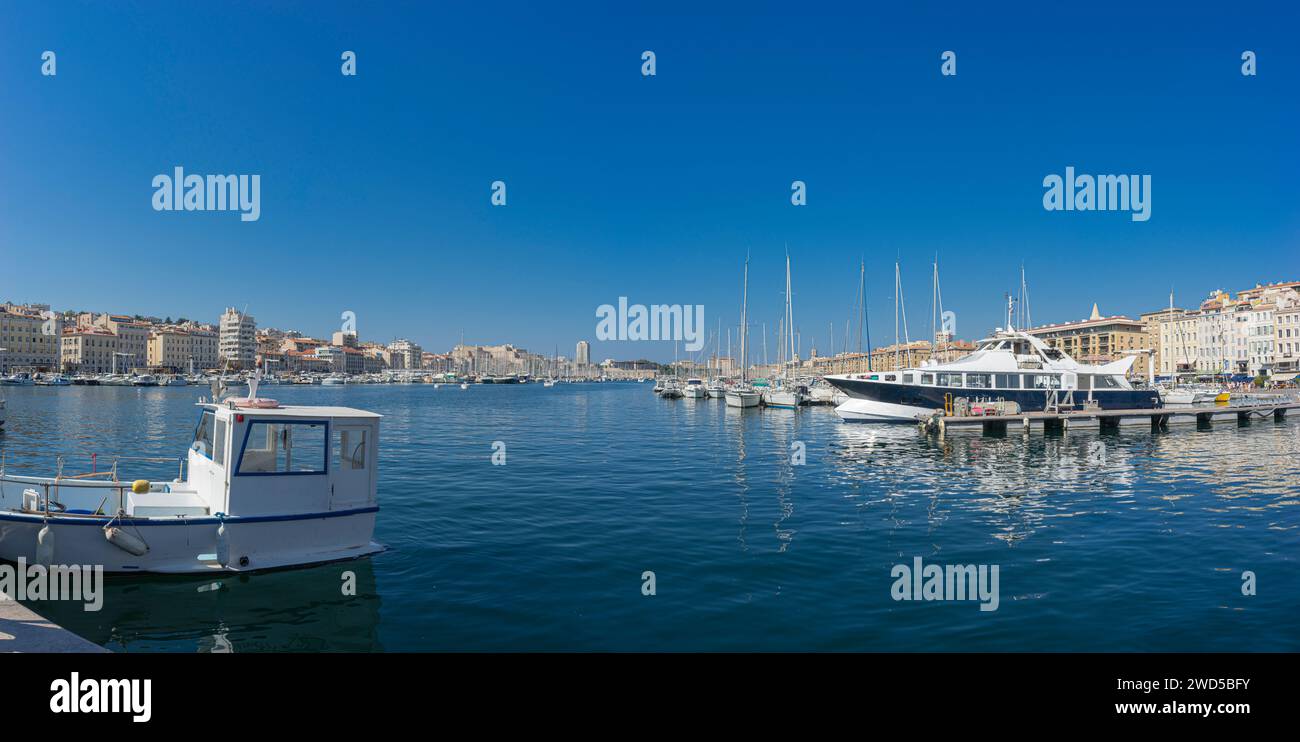 A clear day at the bustling port of Marseille, where a variety of boats ...