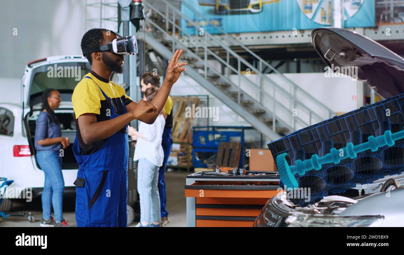 Technician in repair shop using advanced virtual reality technology to ...