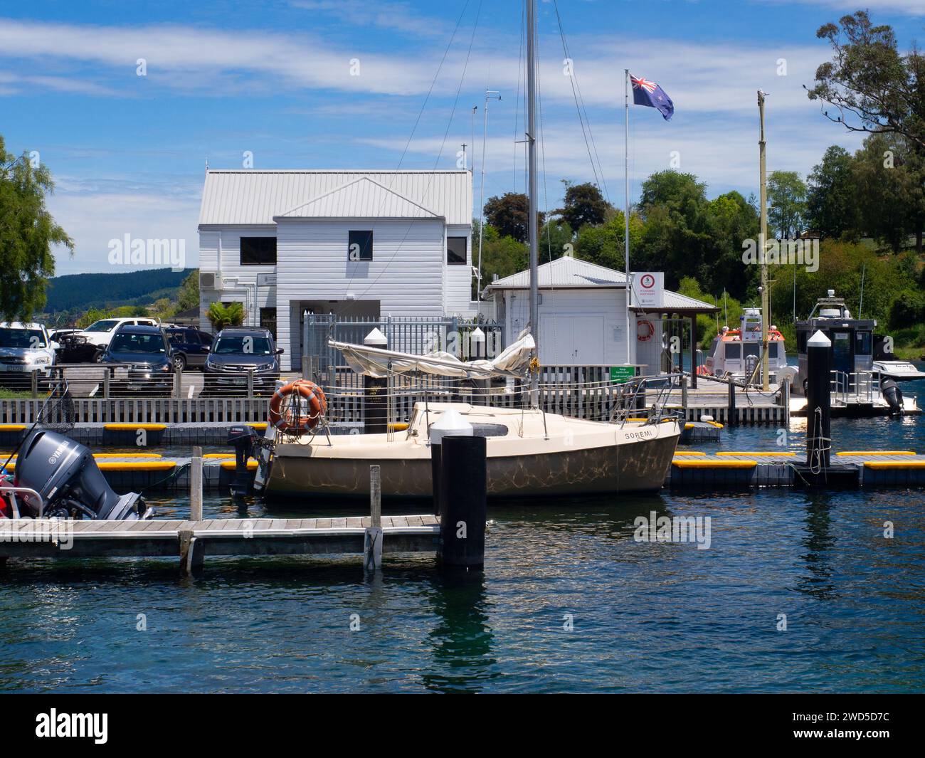 Boats Moored By Jetties Along The Waterfront At Lake Taupo Marina Stock ...