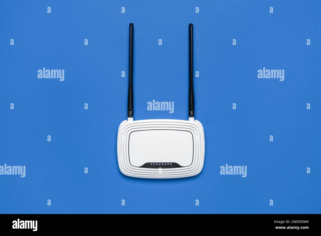 Modern wi-fi router on blue background Stock Photo - Alamy