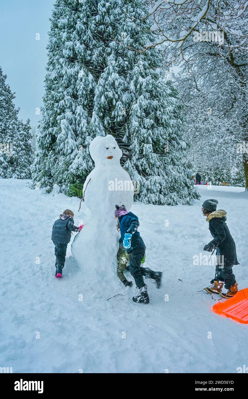 kids, snowman, winter play Stock Photo - Alamy