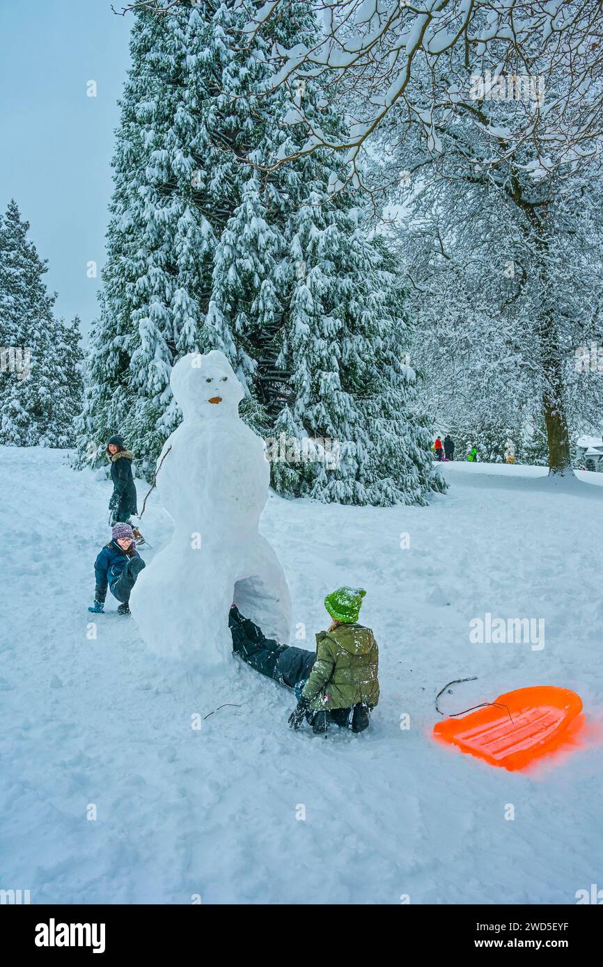 kids, snowman, winter play Stock Photo - Alamy