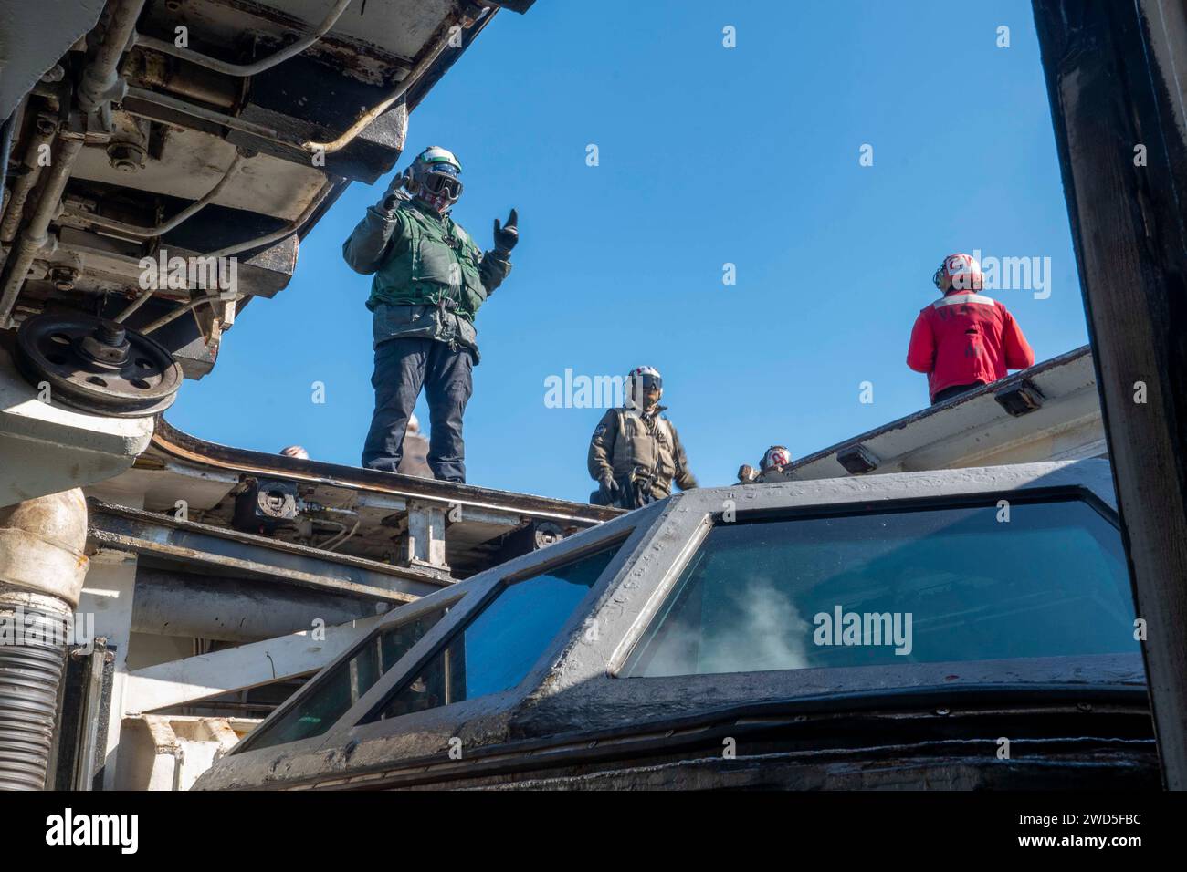 240116-N-TY704-1090 AT SEA (Jan. 16, 2024) Sailors observe an ...