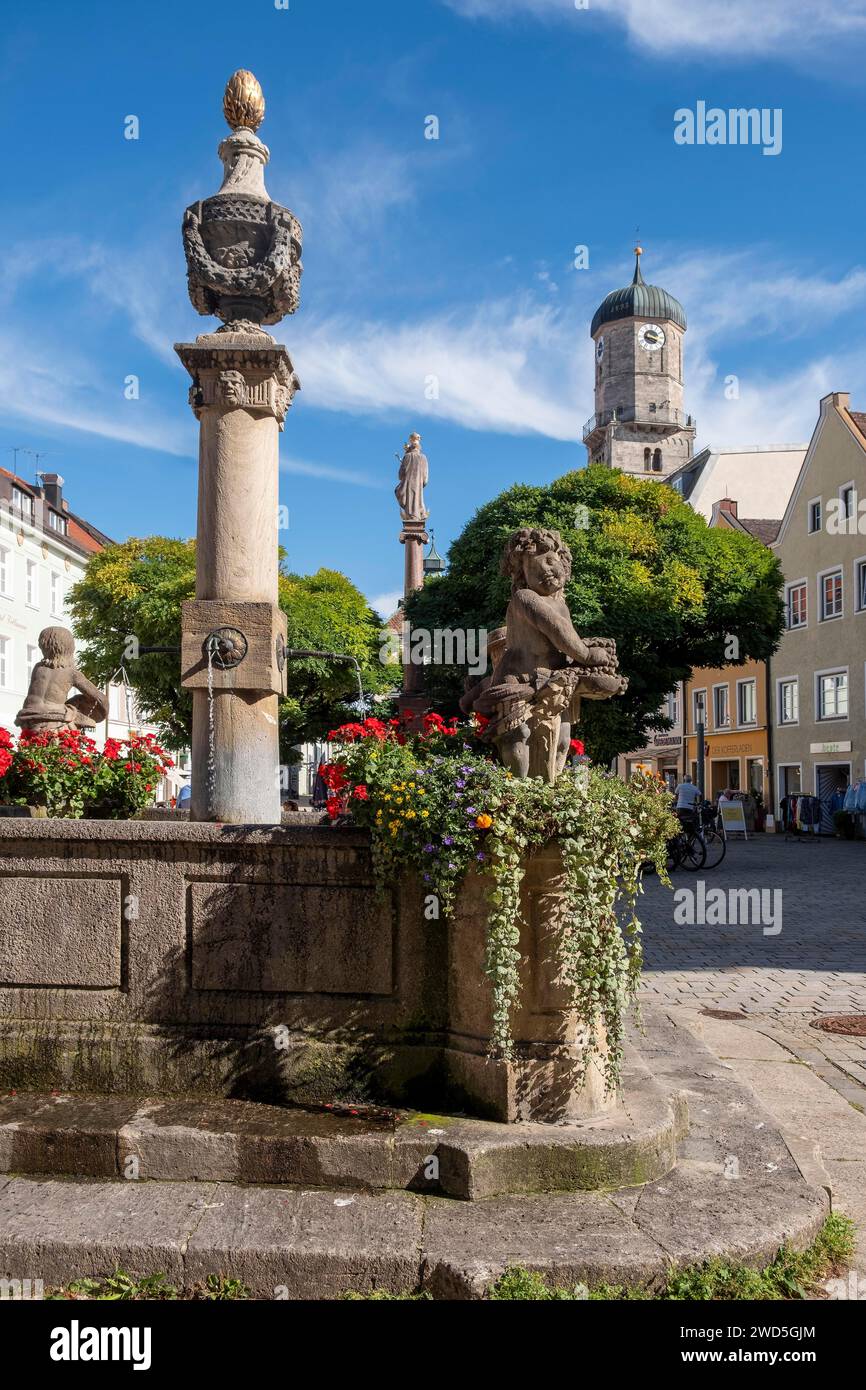Town fountain in front of the tower of the parish church of the ...