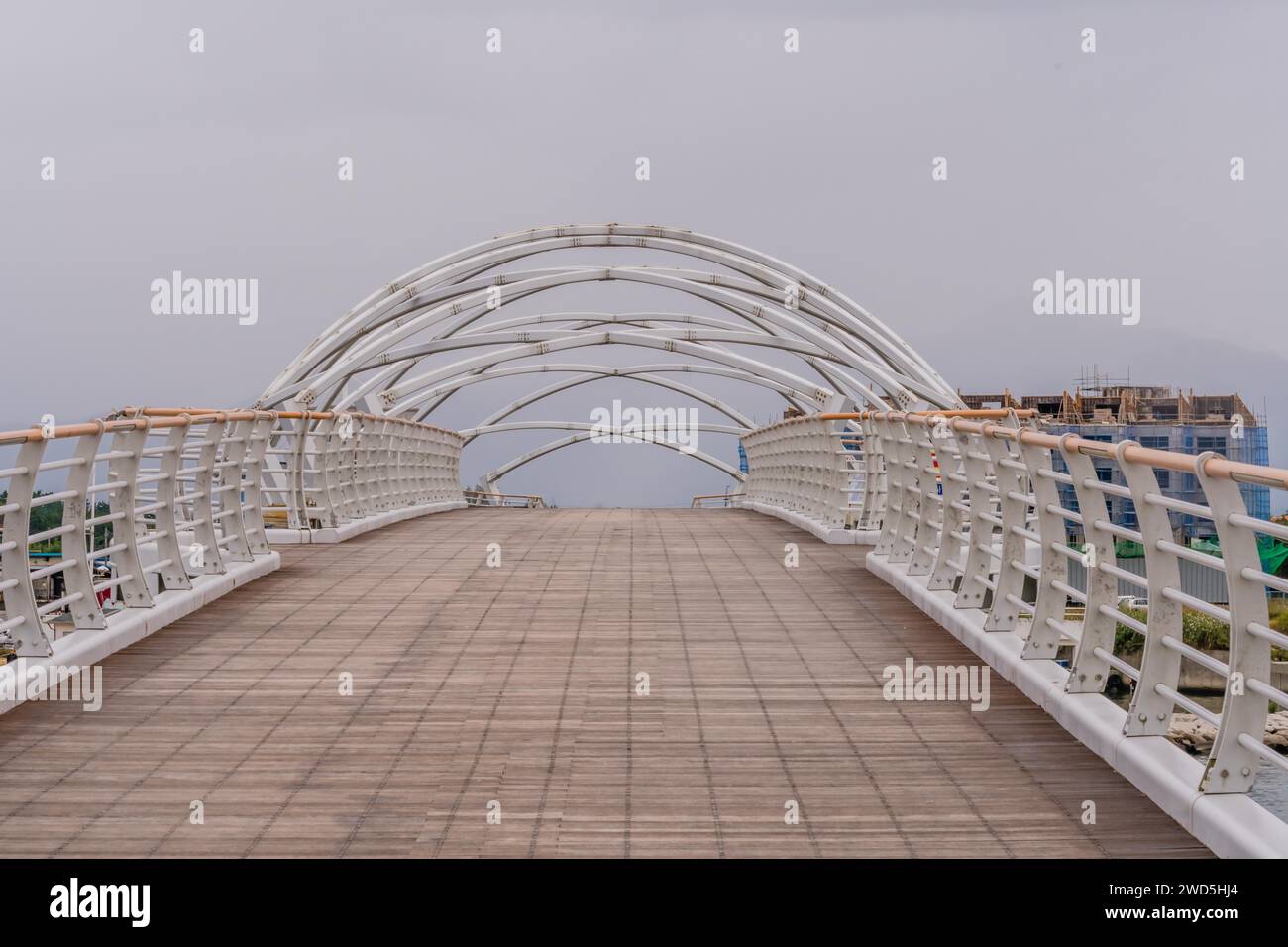 White metal crossbeam foot bridge with metal railings on gray misty morning, South Korea Stock ...