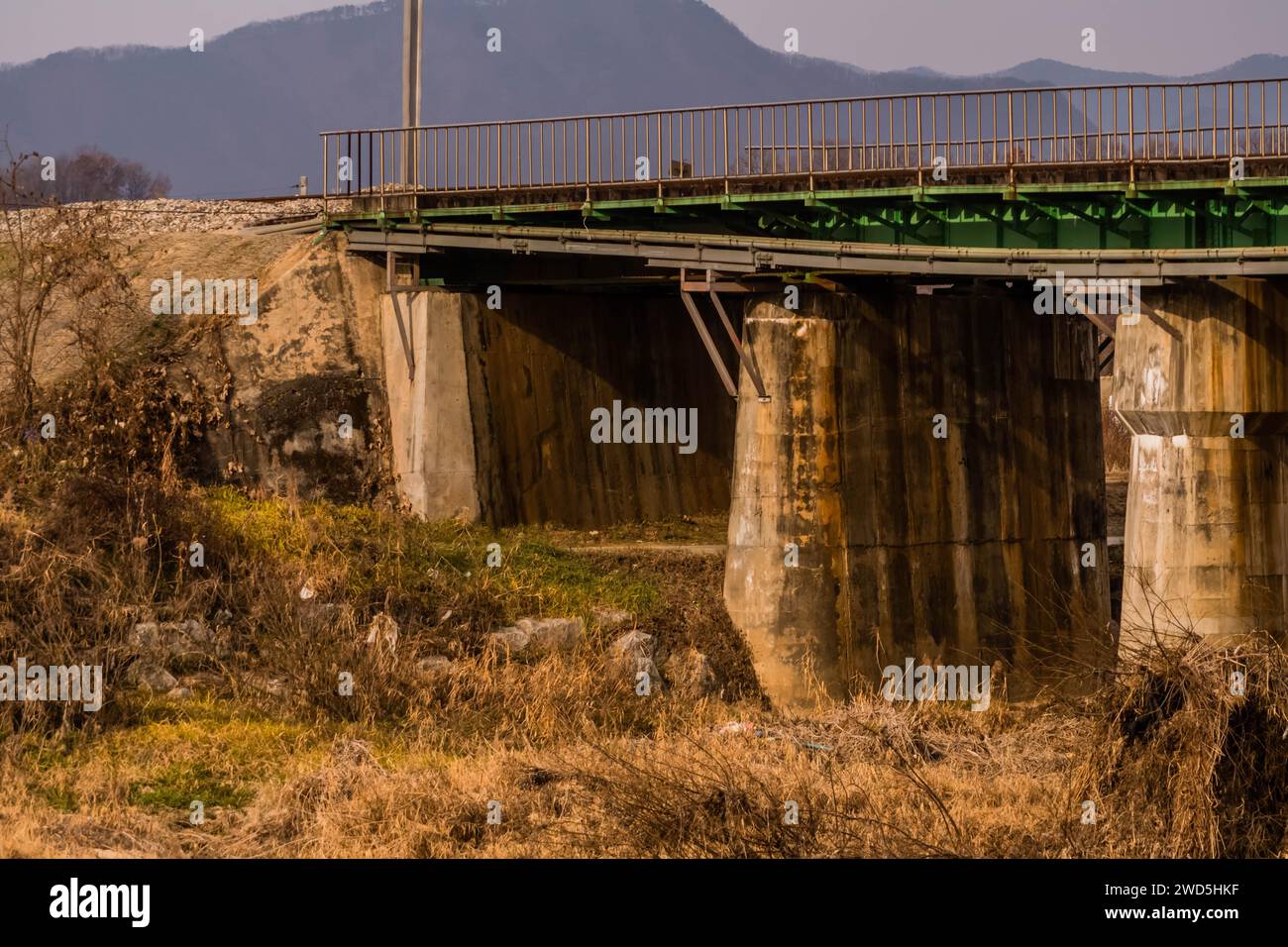 Railroad bridge with large concrete support columns in countryside with ...