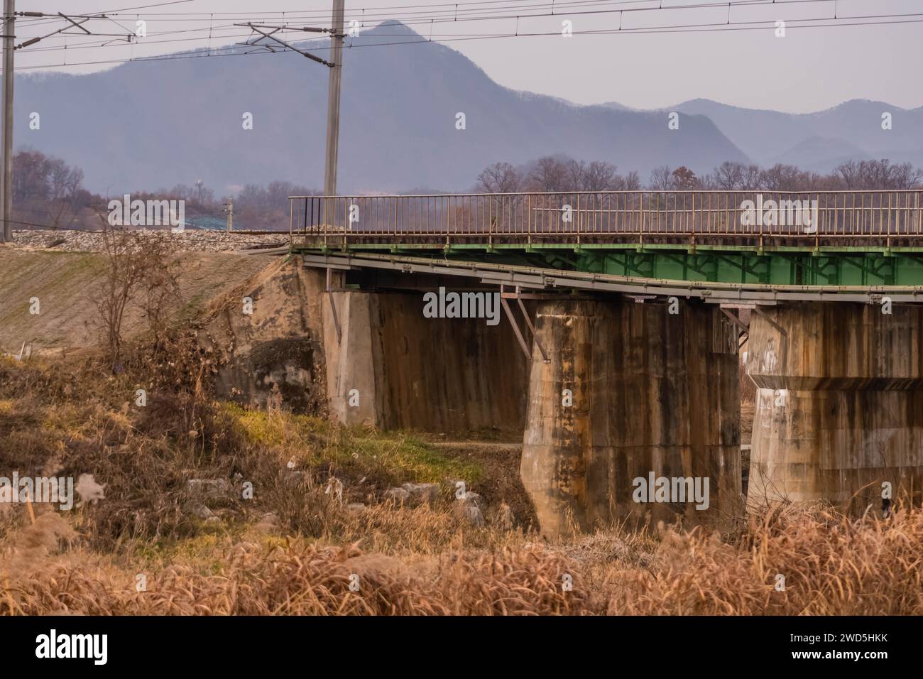Railroad bridge with large concrete support columns in countryside with ...