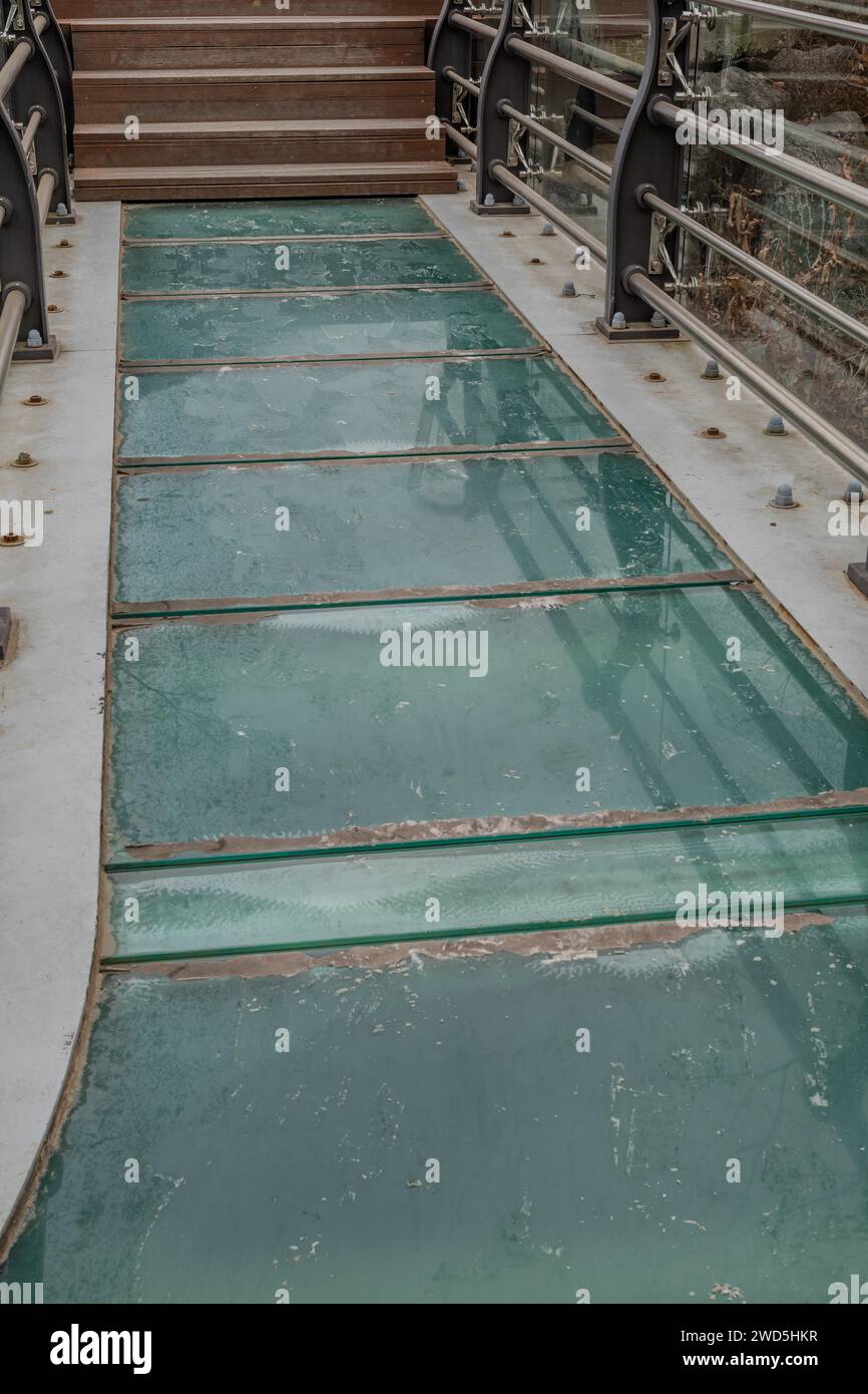Glass walkway leading to wooden stairs of observation platform in ...