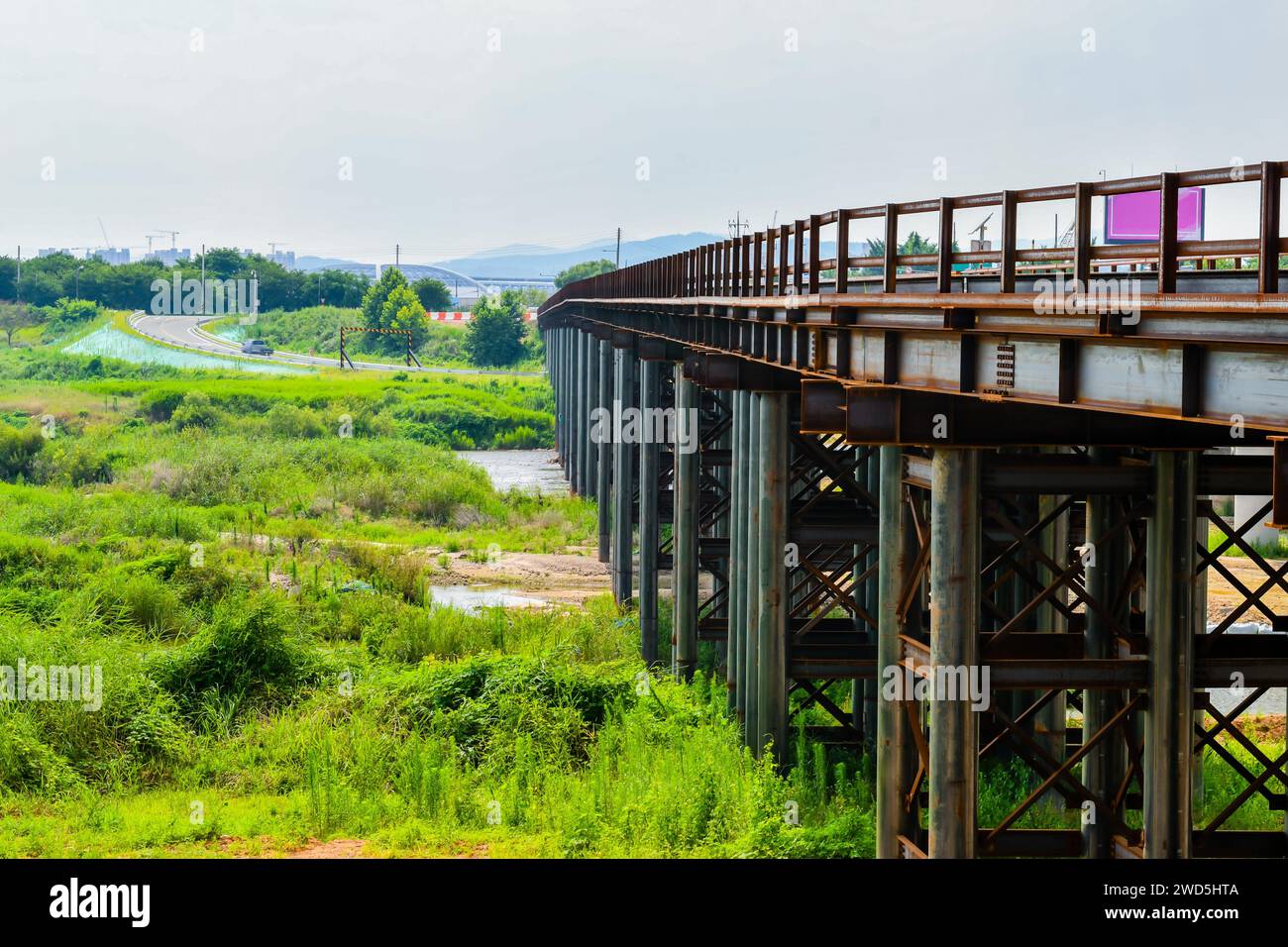 Landscape of iron substructure of bridge under construction over river ...