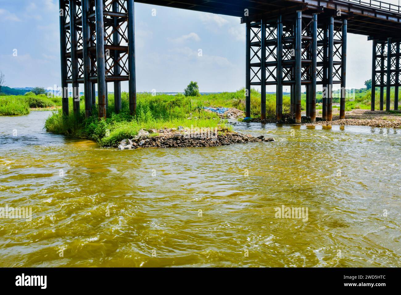 Landscape of iron substructure of bridge under construction over river ...