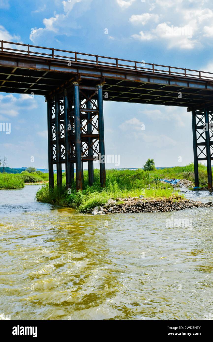 Landscape of iron substructure of bridge under construction over river ...