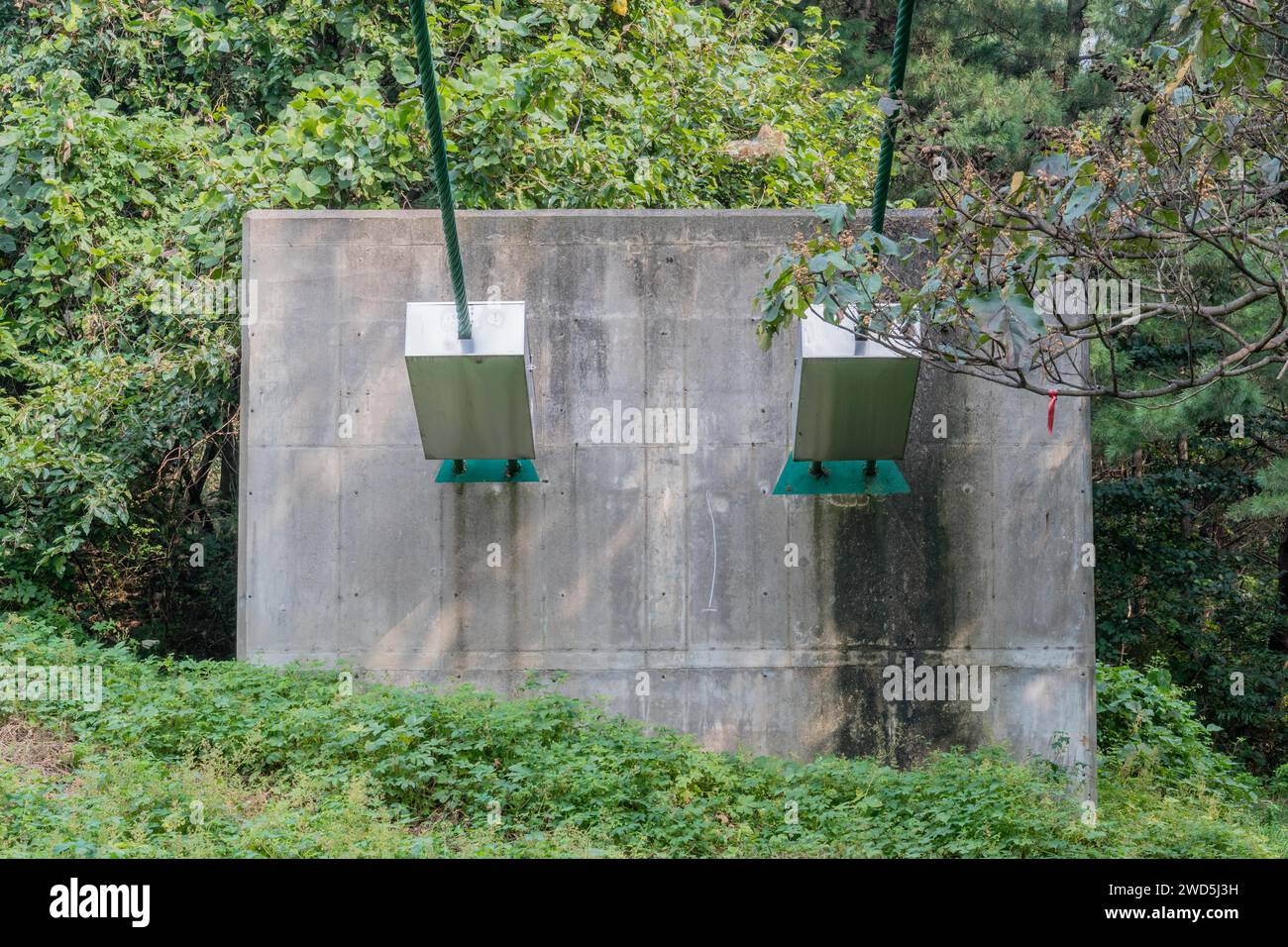 End cables of suspension bridge anchored in large square of concrete ...