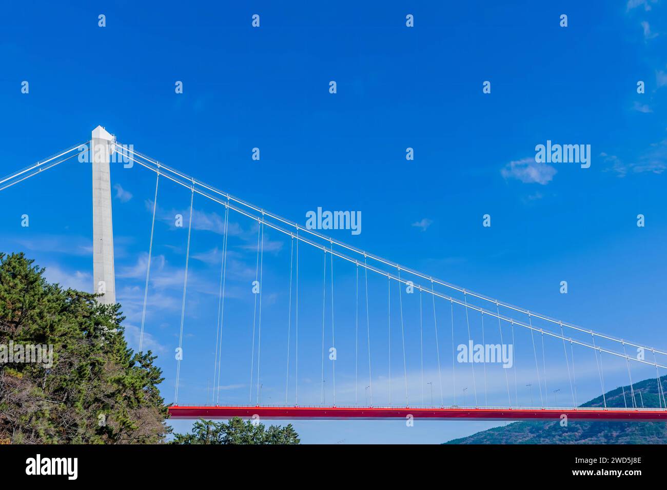 Pylons of suspension bridge on highway under blue sky, South Korea ...