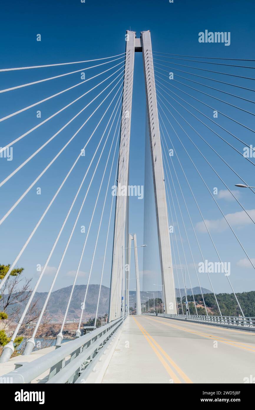 Two lane road across cable stay suspension bridge in rural countryside ...