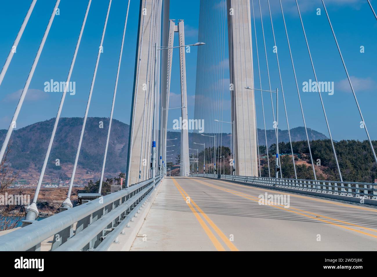 Two lane road across cable stay suspension bridge in rural countryside ...