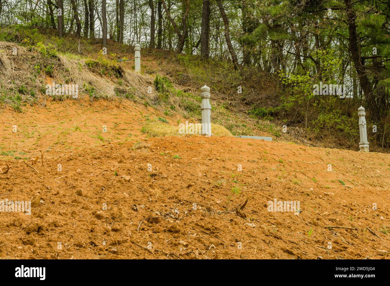 Burial mound in freshly dug grave site in mountainside wilderness area ...
