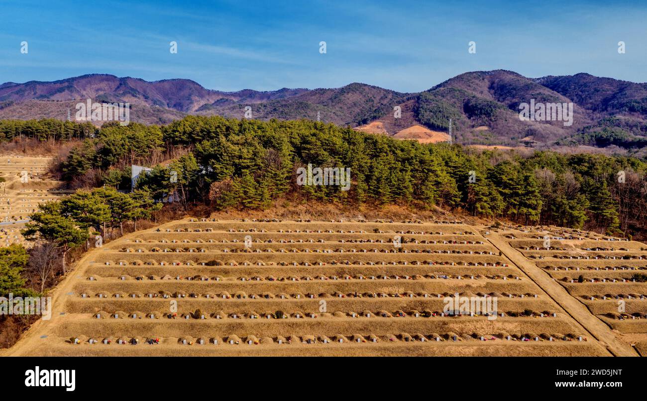 Aerial view of burial mounds on hillside of rural graveyard, South ...