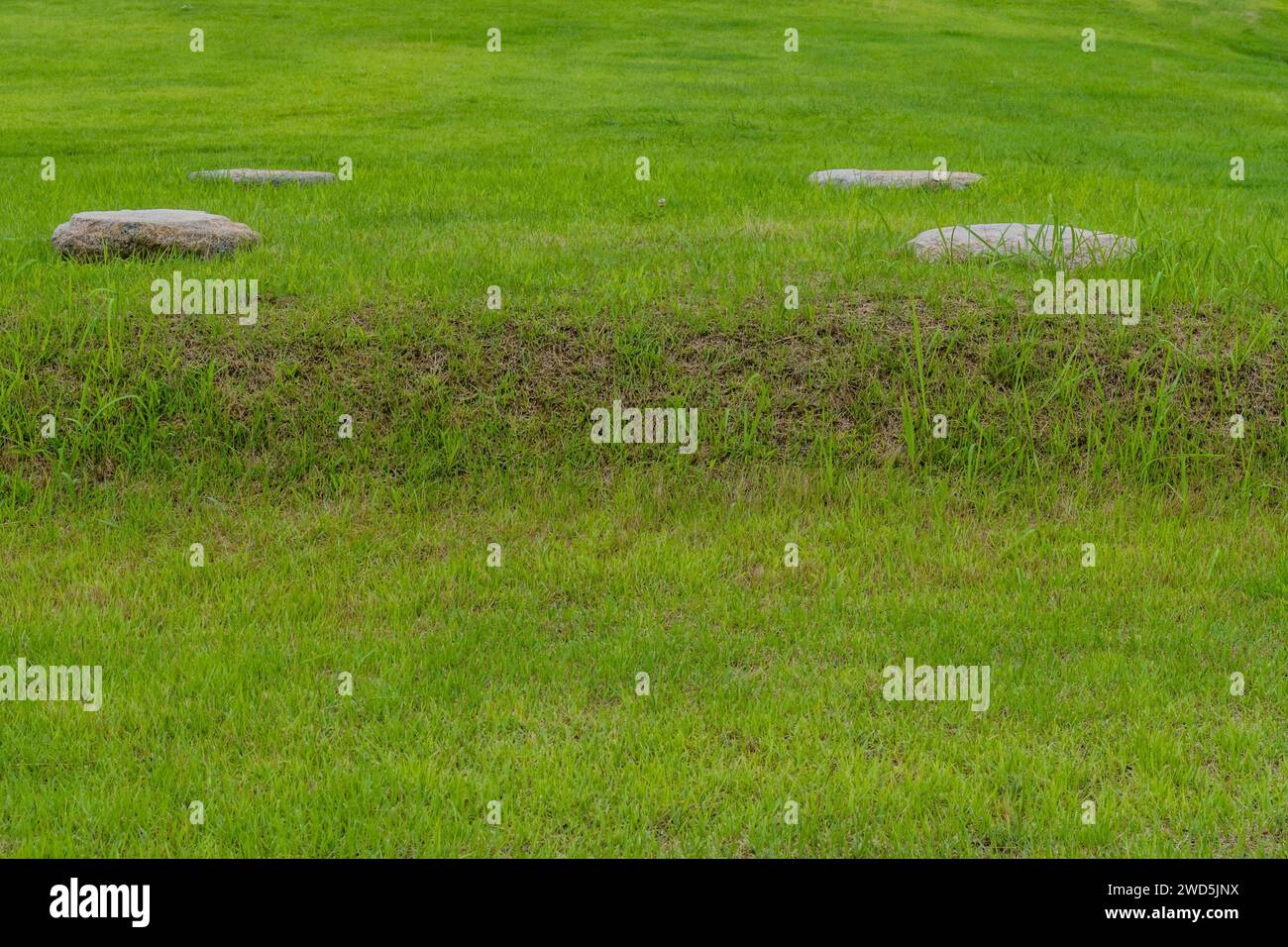 Four round stones on mound of archeological site in Buyeo, South Korea ...
