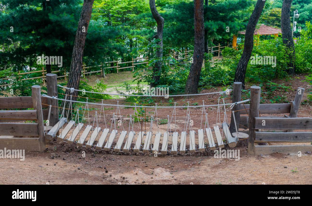 Hanging rope bridge, part of exercise and obstacle course in public ...
