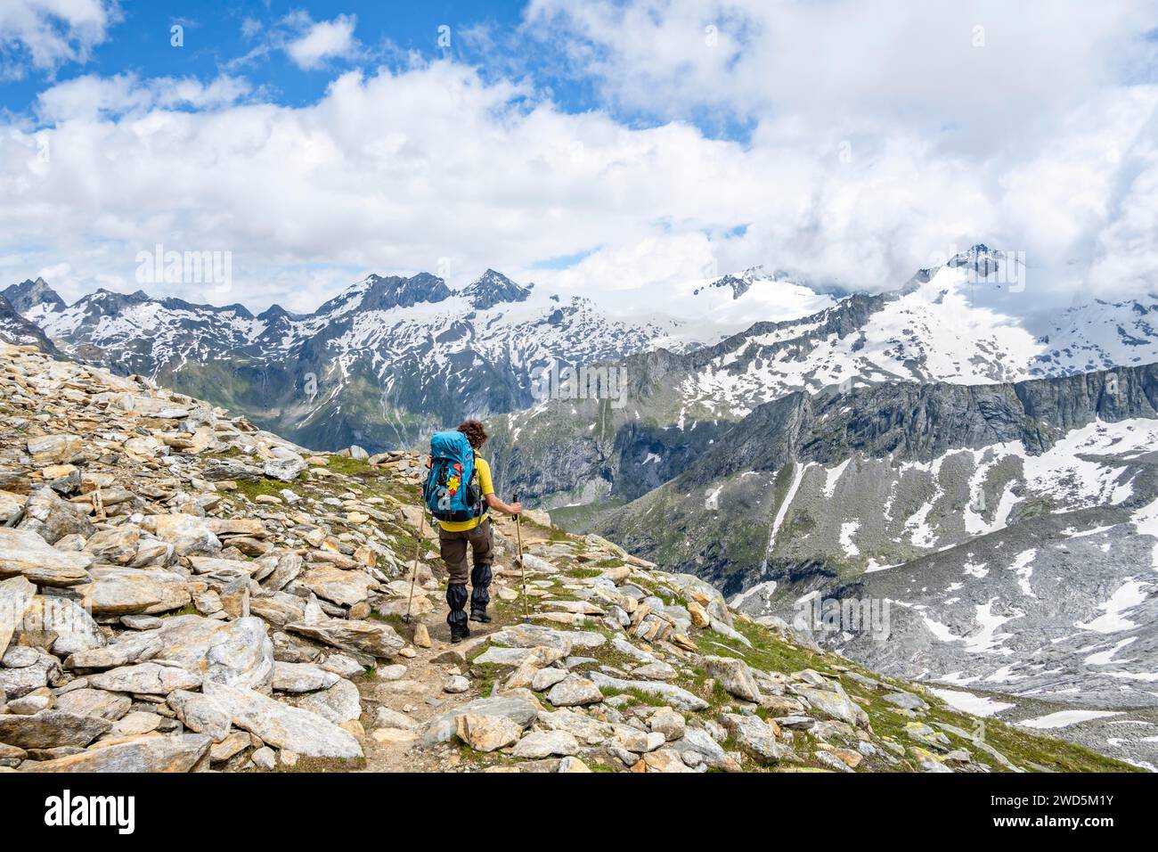 Mountaineer on a hiking trail in front of a picturesque mountain ...