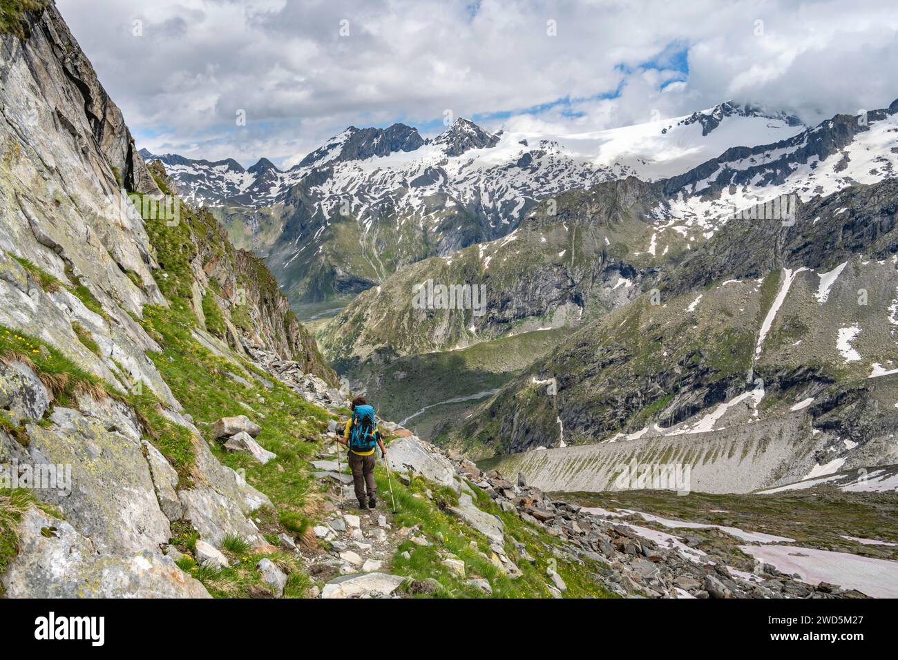 Mountaineer on a hiking trail in front of a picturesque mountain ...