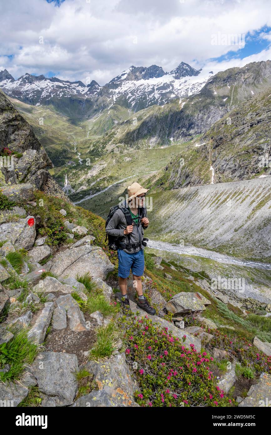 Mountaineer on hiking trail in front of picturesque mountain landscape ...
