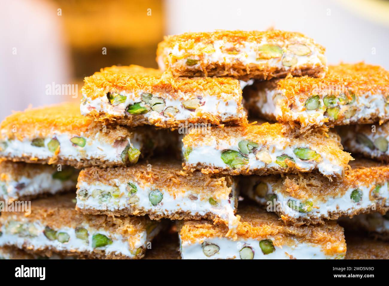 Turkish traditional dessert Kadayif baked in syrup served with nut ...