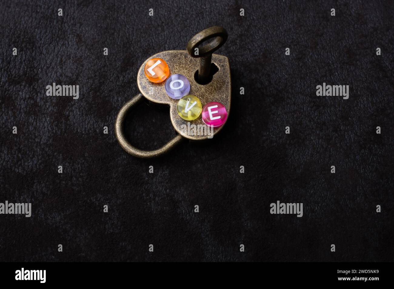 Love shaped padlock, key and love wording on black background Stock ...