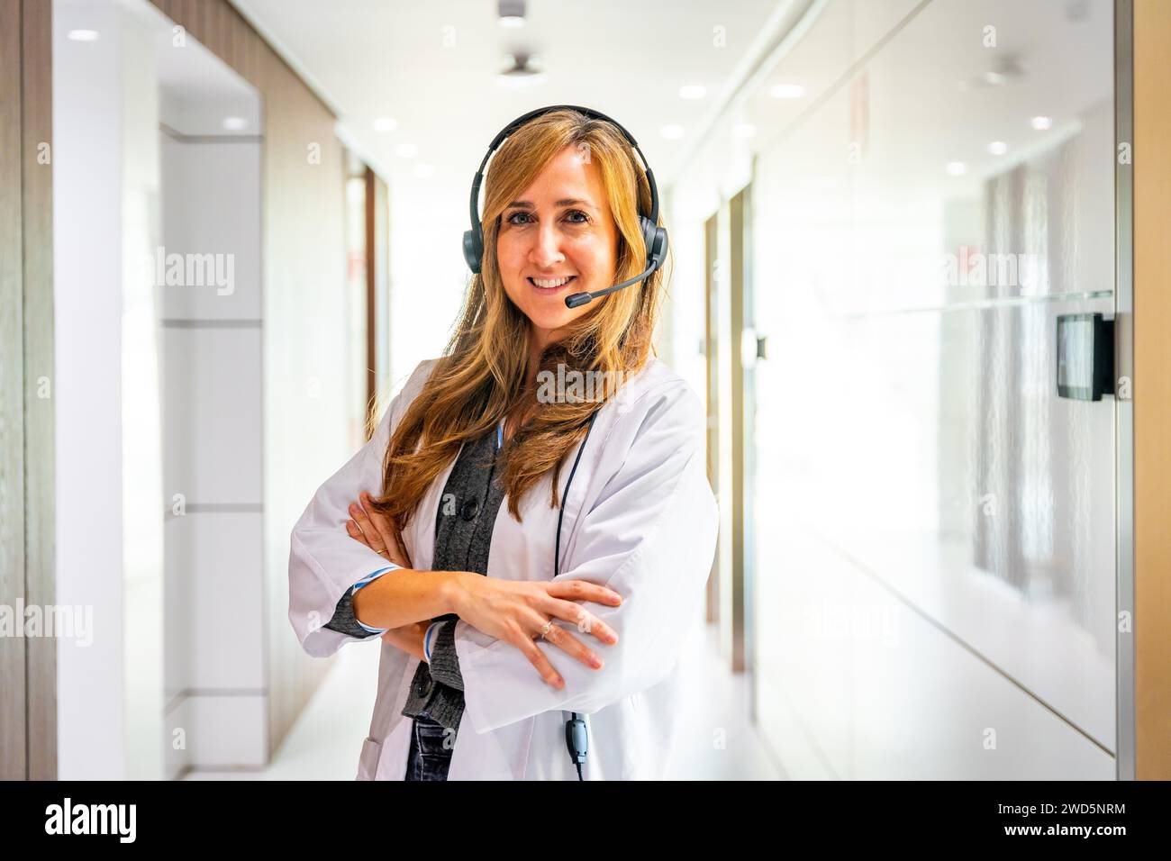 Portrait of a proud female hospital receptionist wearing headset to ...