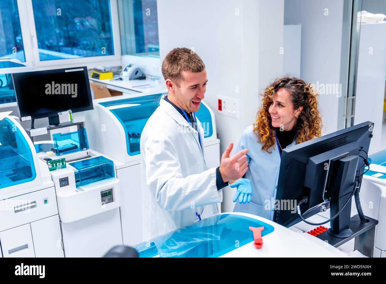 Young scientists working using computer in a modern laboratory of an hospital in the pathology ...
