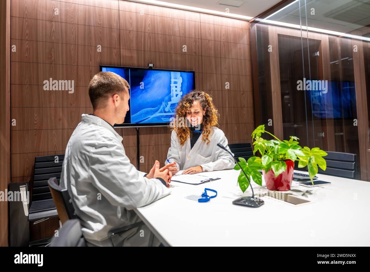 Team of doctors examining x-ray scans and writing medical report ...