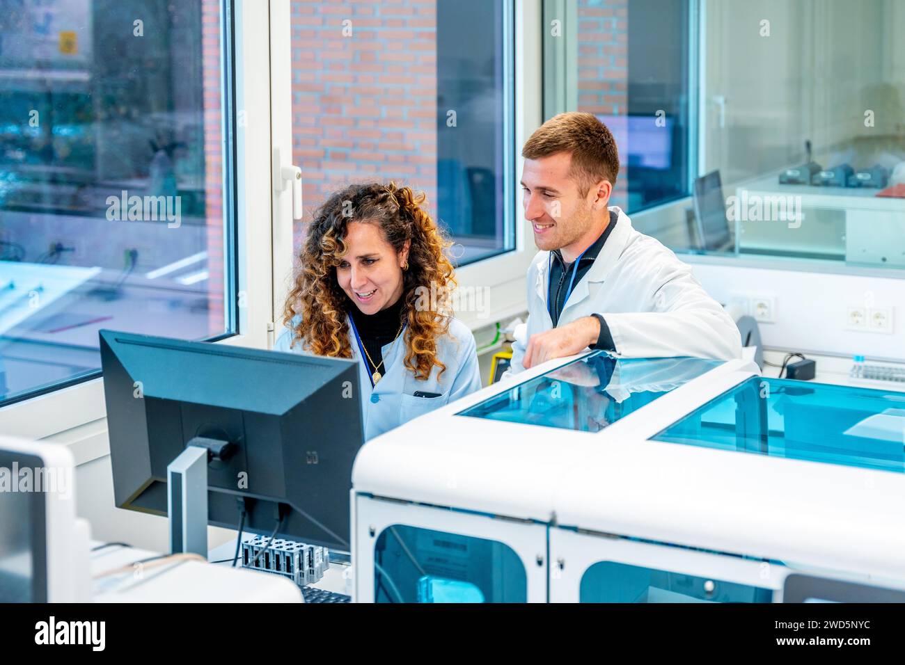 Two young medical scientists working in a pathology analysis laboratory ...