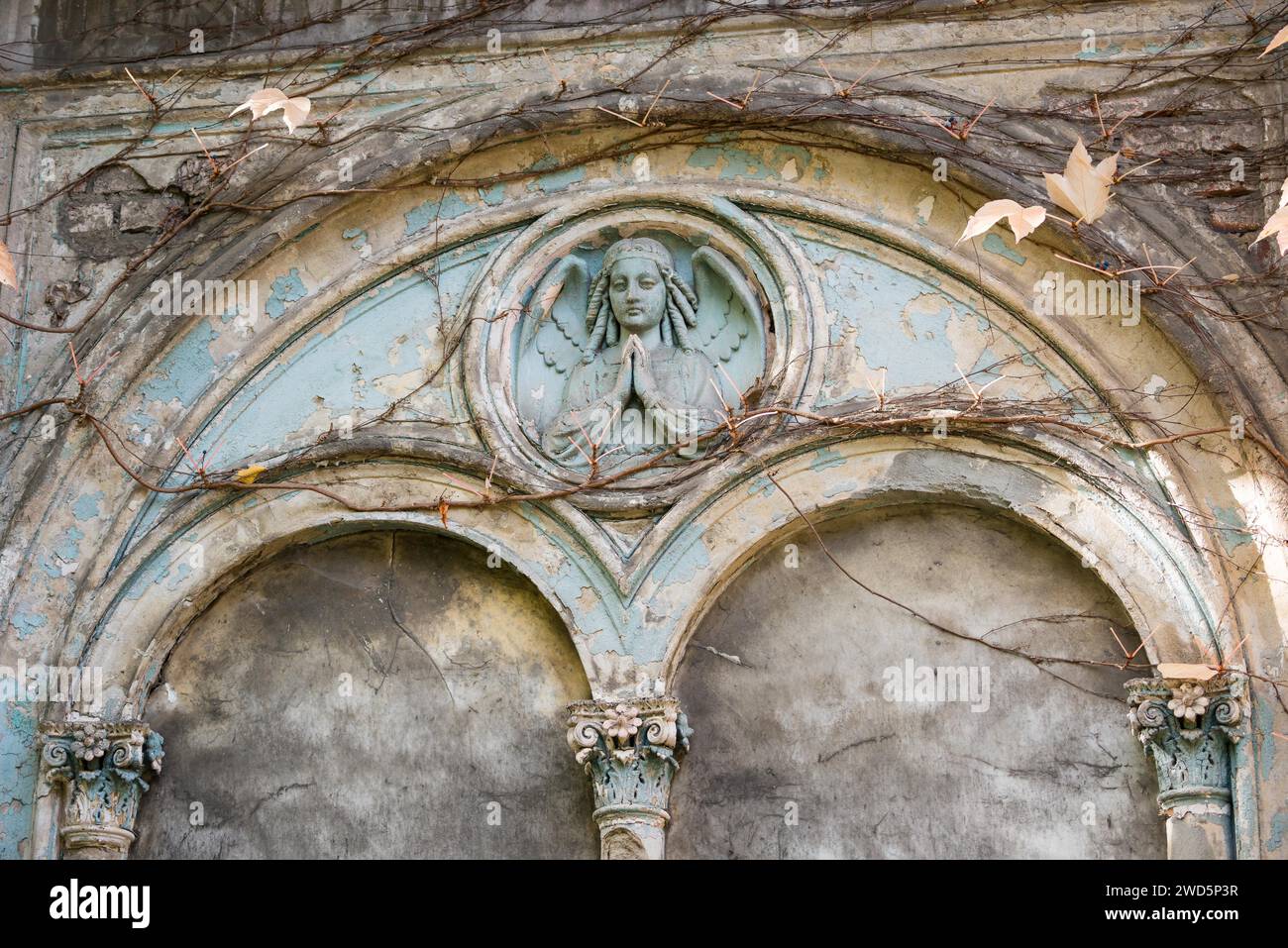 Relief of an angel on a dilapidated blue facade, historical angel ...