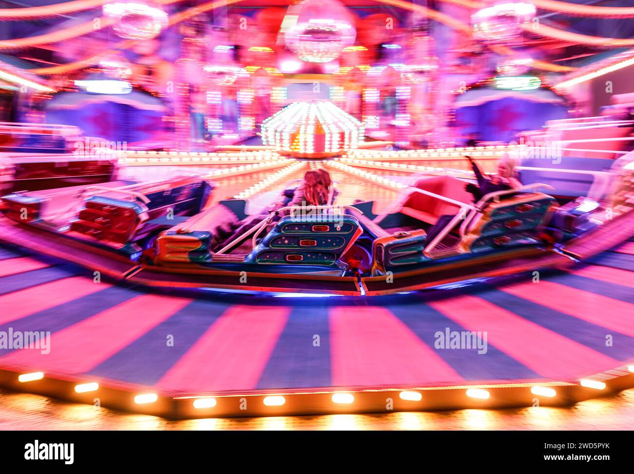 Visitors ride in a Musik Express ride, Berlin, 09.12.2022 Stock Photo ...