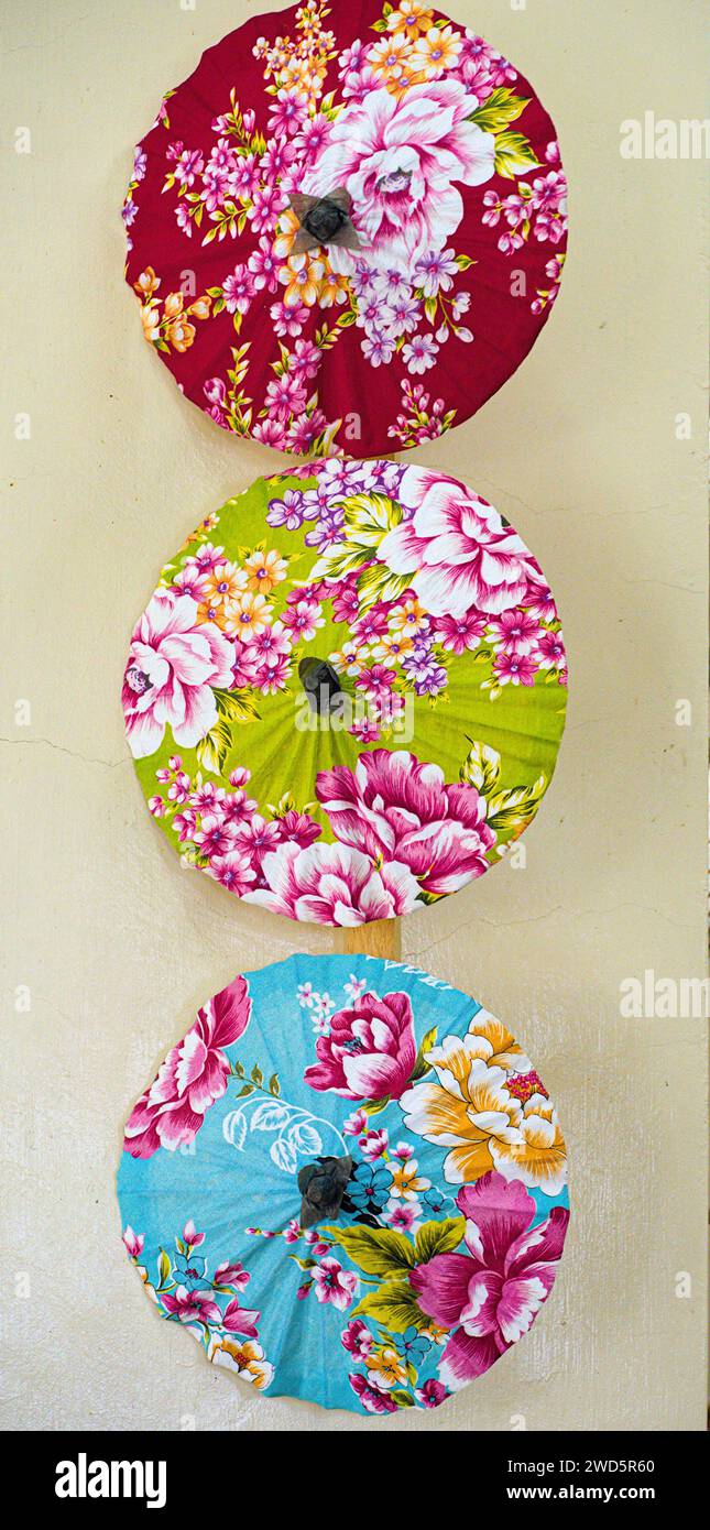 Three colorful umbrellas on the wall Stock Photo - Alamy