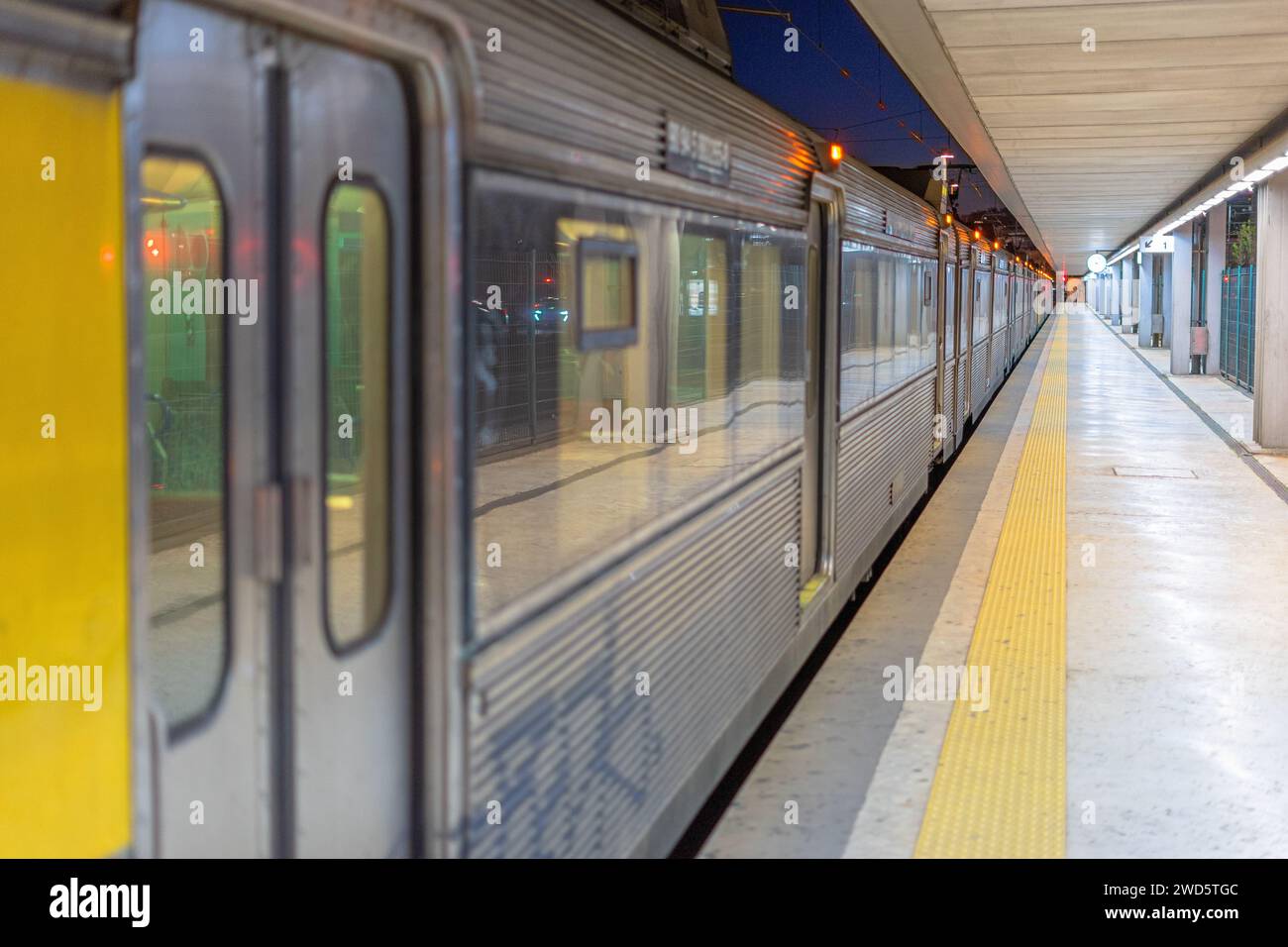 railway station with train carriages on the left and a deep corridor on ...