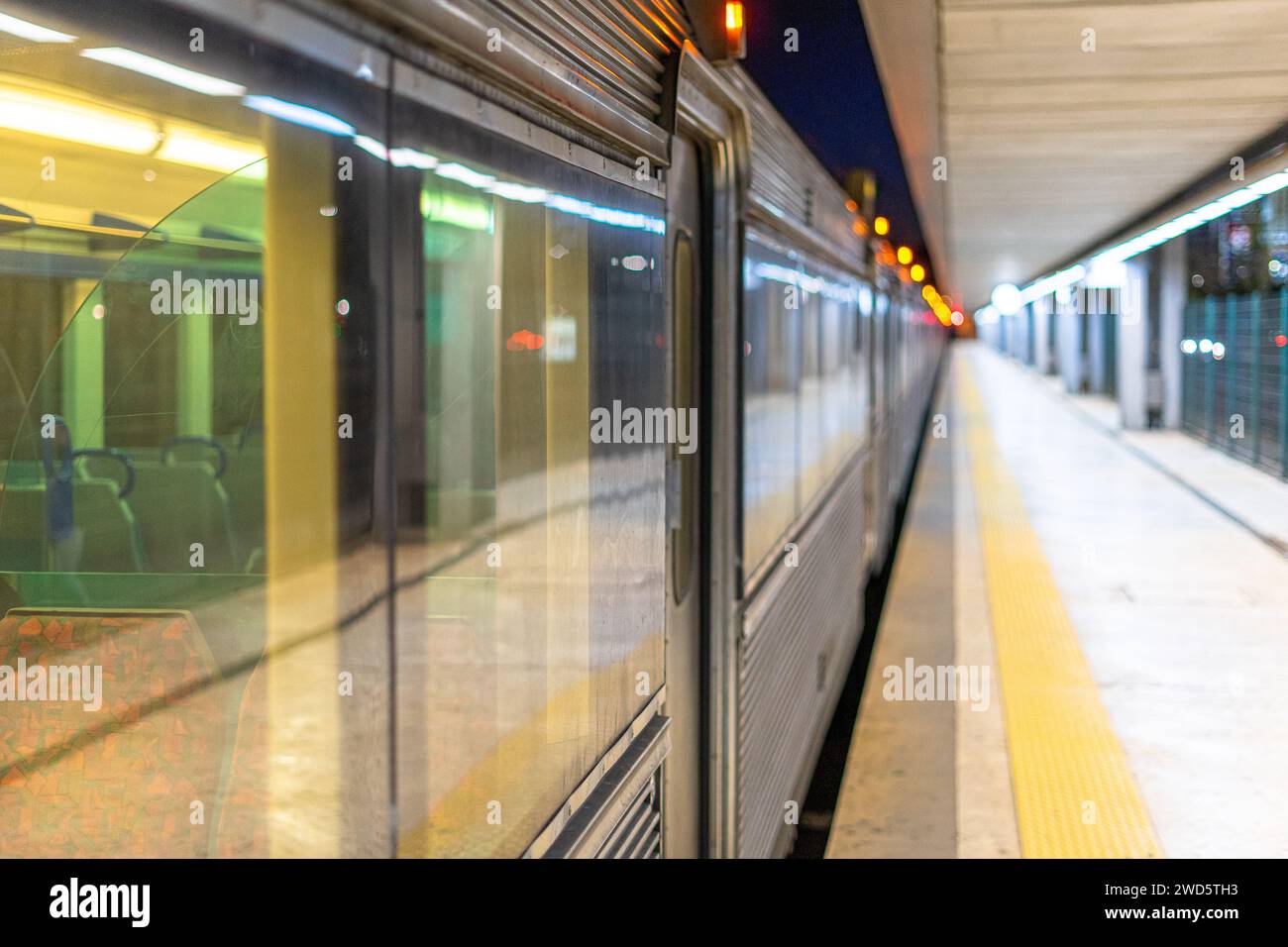 railway station with train carriages on the left and a deep corridor on ...