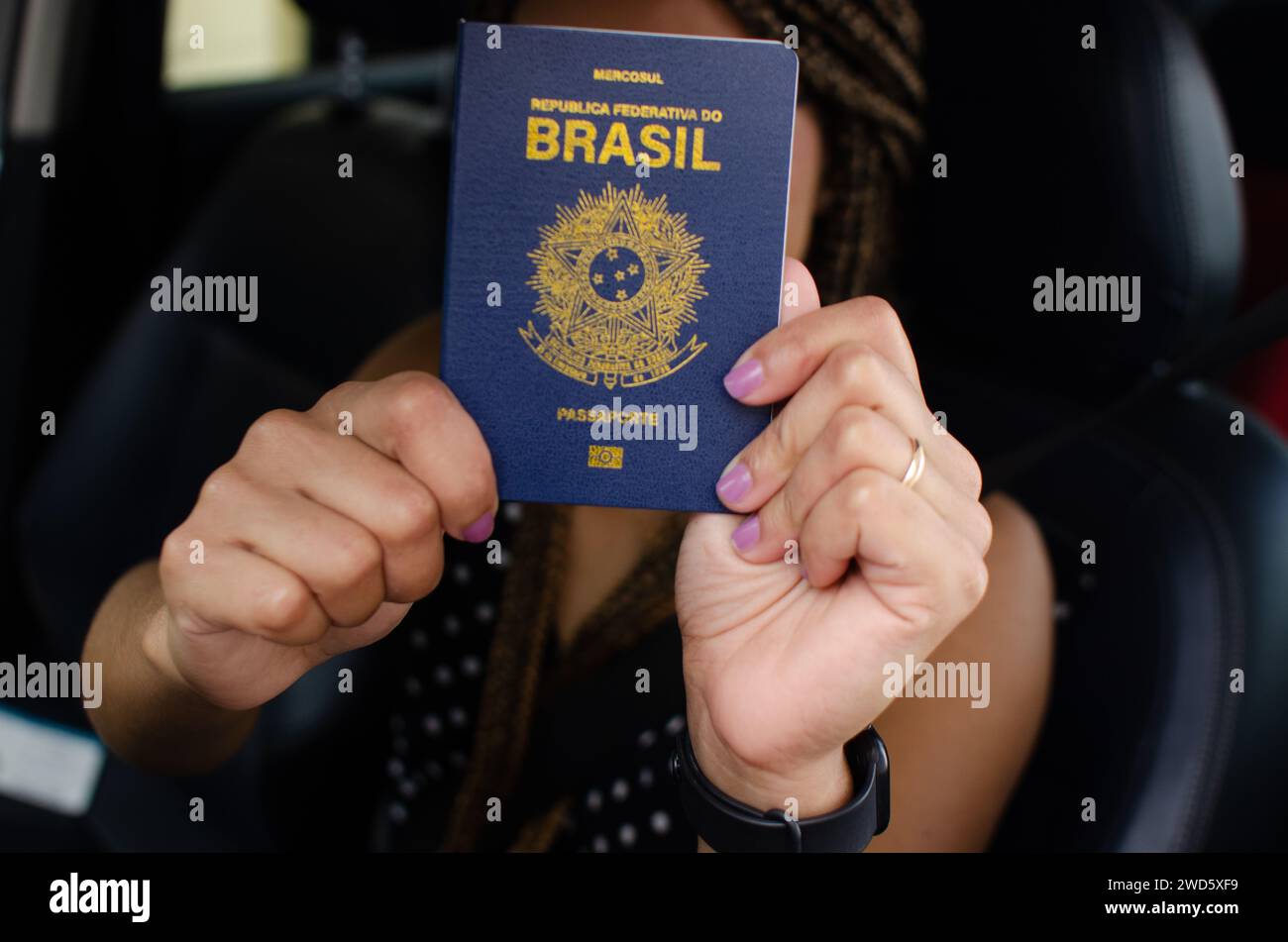 Hand holding the Brazilian passport in a close-up, symbolizing the ...