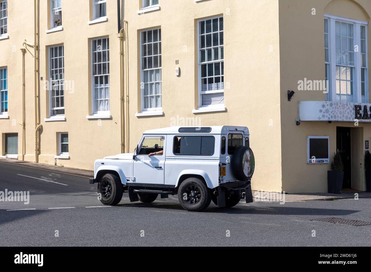 white Land Rover Defender 90 driving through Swanage, Dorset,England,UK ...